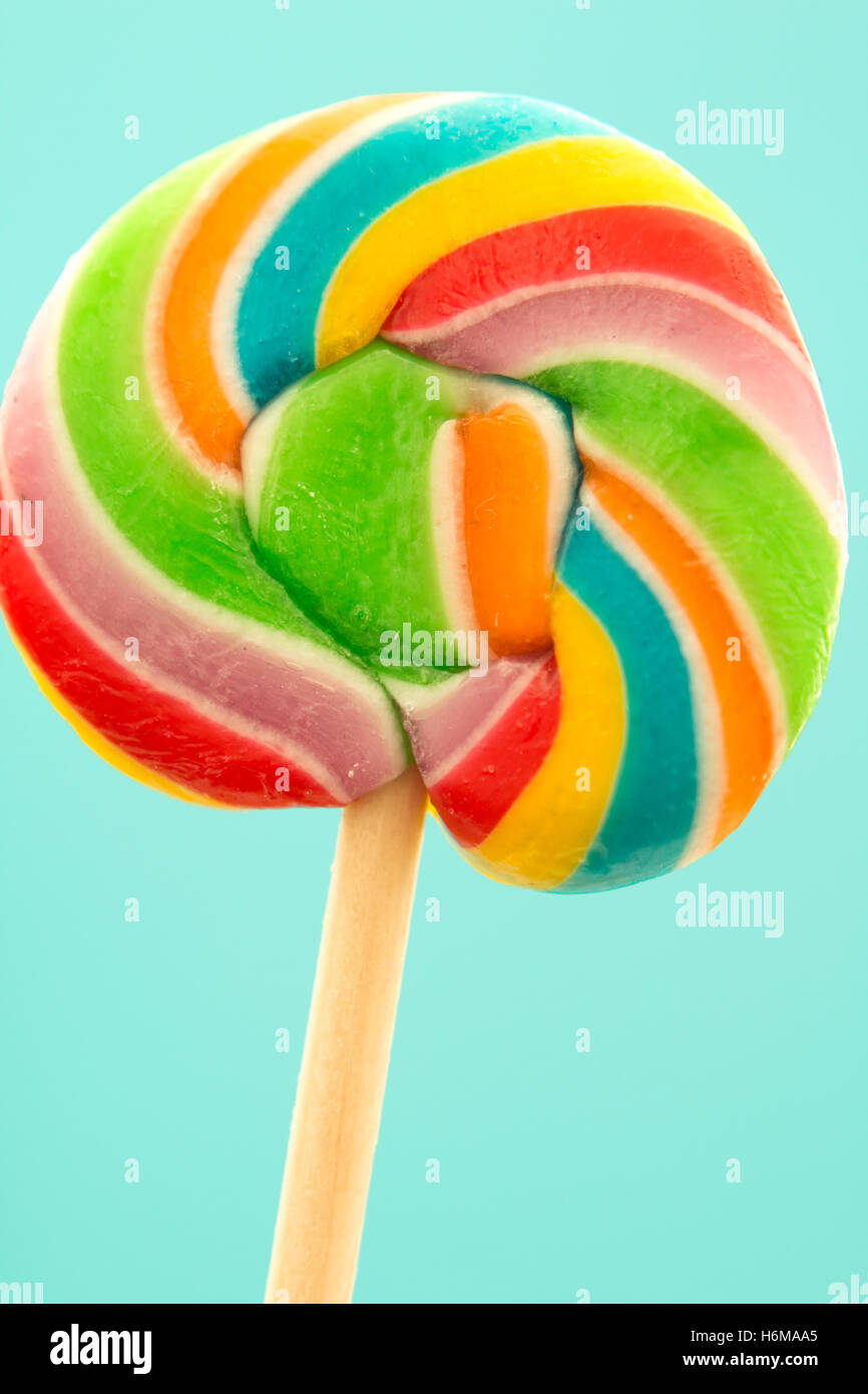 Nice lollipop with many colors in a spiral on a blue background Stock ...