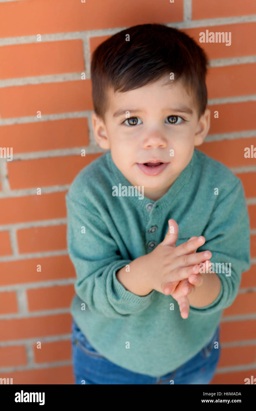 Cheerful child playing palms on the street Stock Photo - Alamy