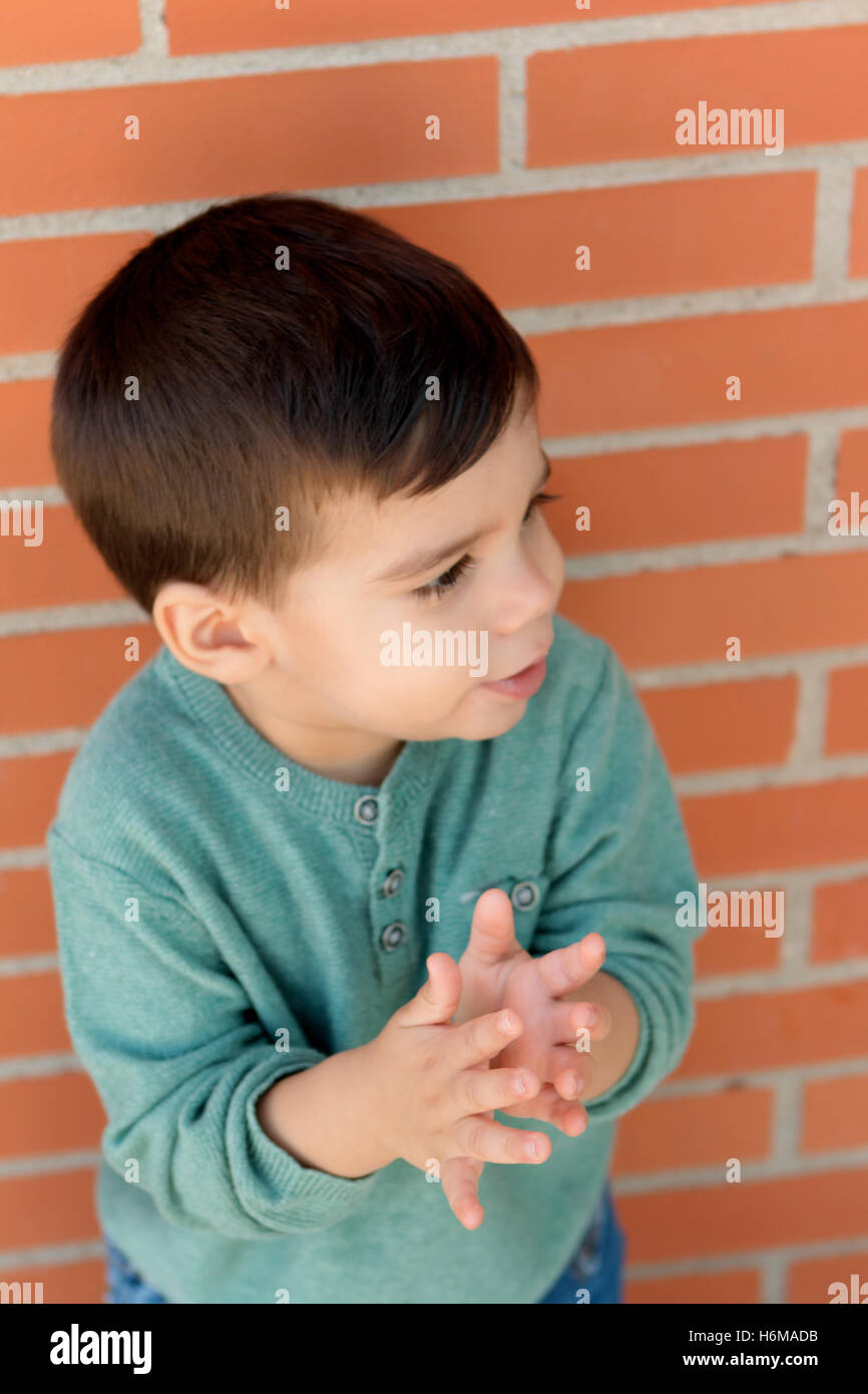 Cheerful child playing palms on the street Stock Photo - Alamy