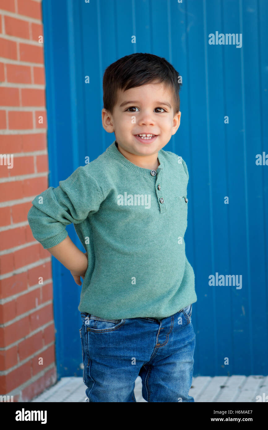 Cheerful child with two years making gestures on the street Stock Photo ...