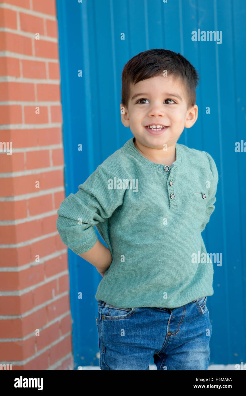 Cheerful child with two years making gestures on the street Stock Photo ...