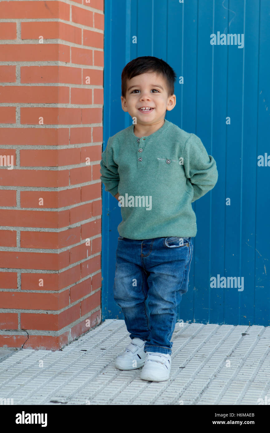 Cheerful child with two years making gestures on the street Stock Photo ...