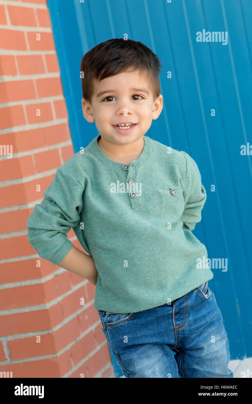 Cheerful child with two years making gestures on the street Stock Photo ...