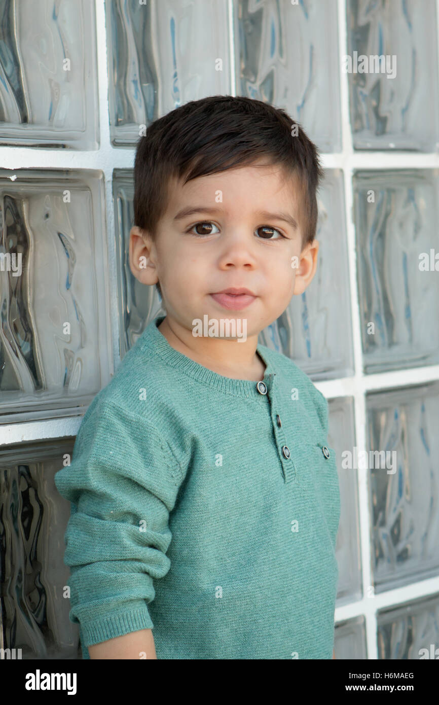 Cheerful child with two years making gestures on the street Stock Photo ...
