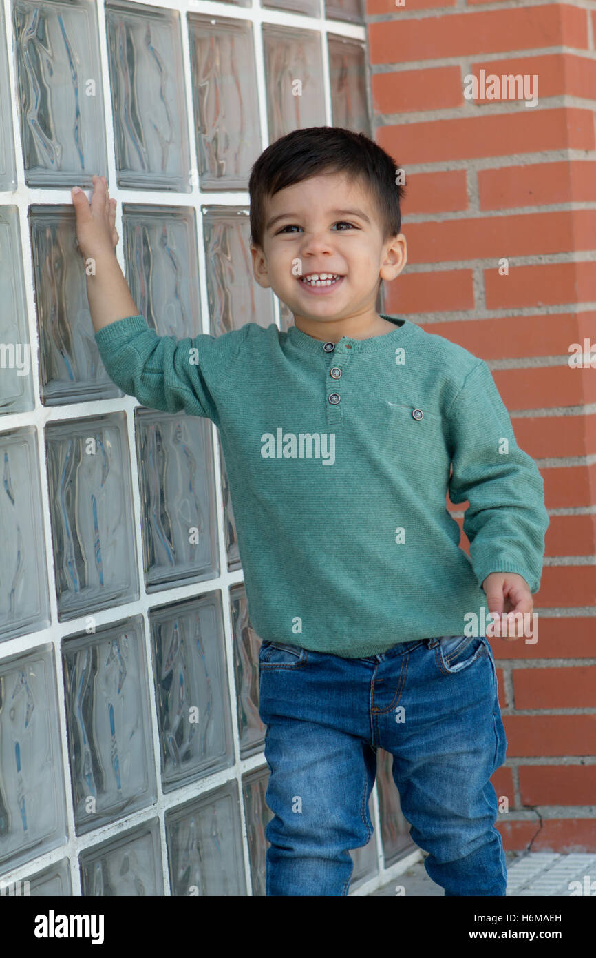 Cheerful child with two years making gestures on the street Stock Photo ...
