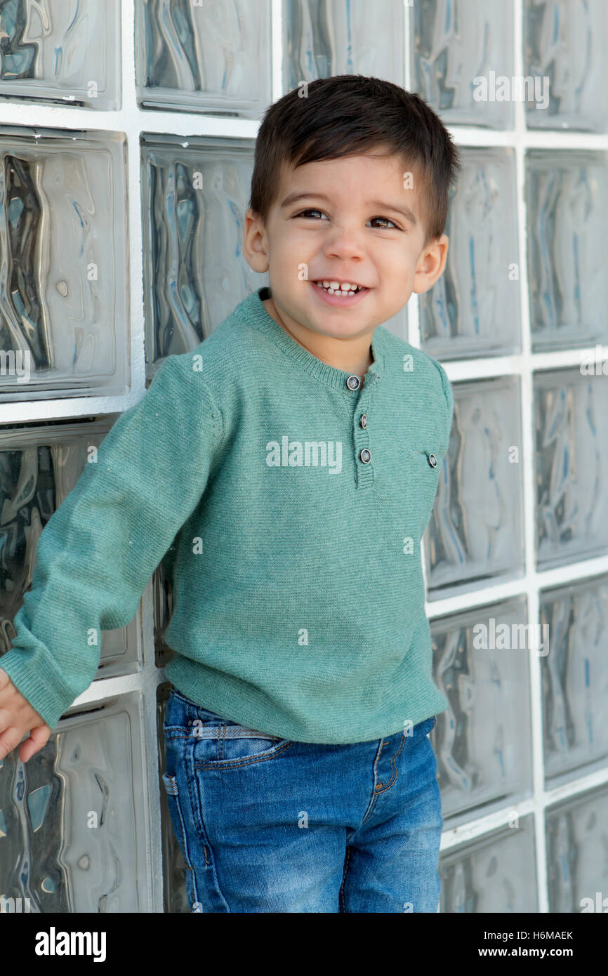 Cheerful child with two years making gestures on the street Stock Photo ...