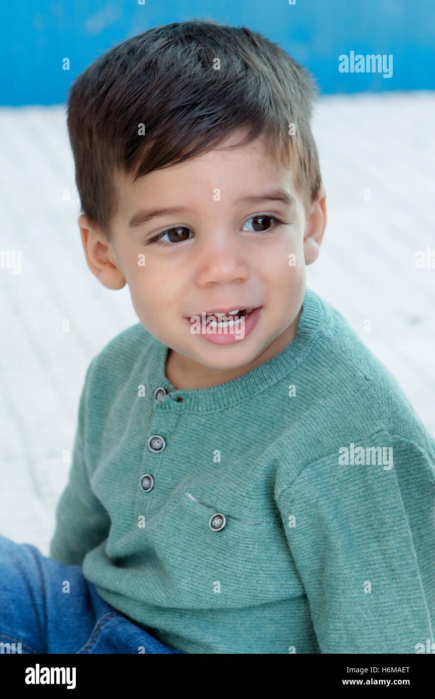 Cheerful child with two years making gestures on the street Stock Photo ...