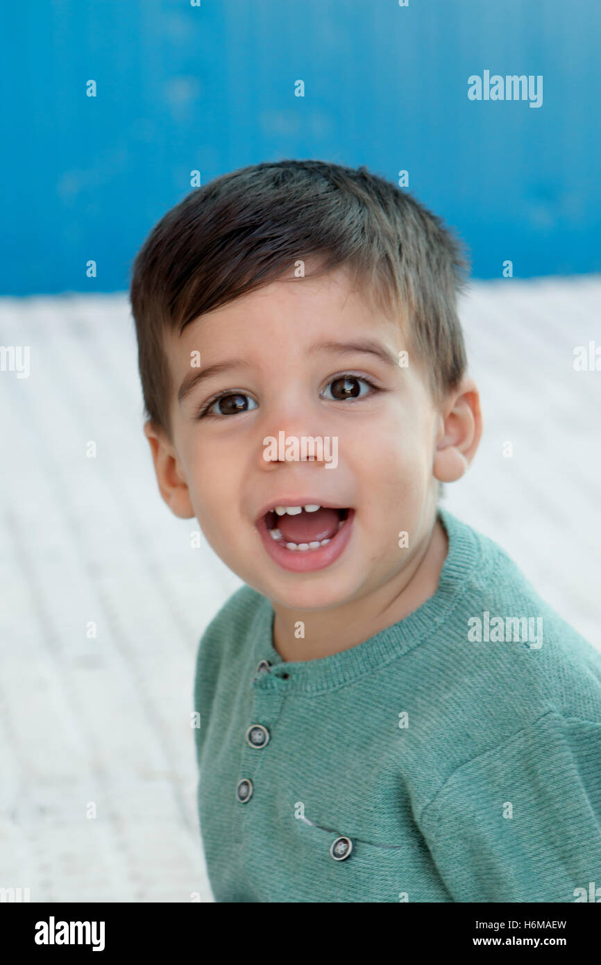 Cheerful child with two years making gestures on the street Stock Photo ...