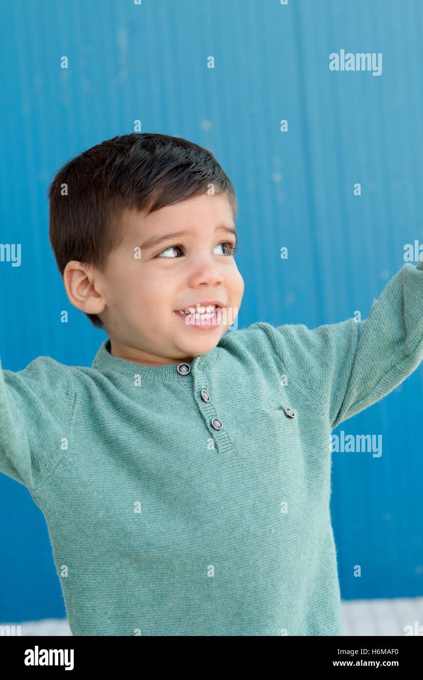 Cheerful child with two years making gestures on the street Stock Photo ...