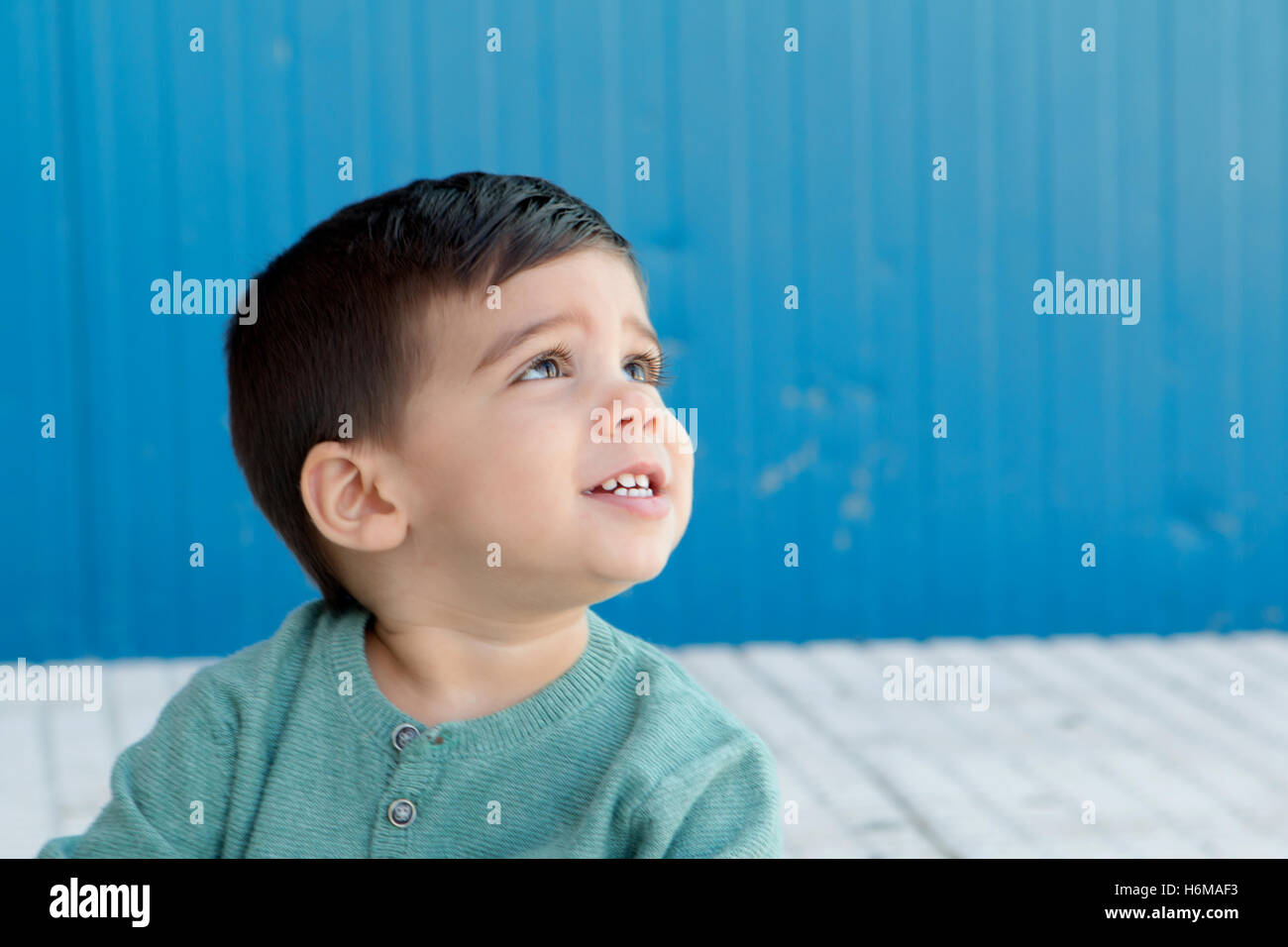 Cheerful child with two years making gestures on the street Stock Photo ...