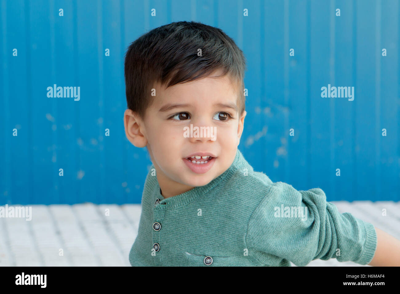Cheerful child with two years making gestures on the street Stock Photo ...