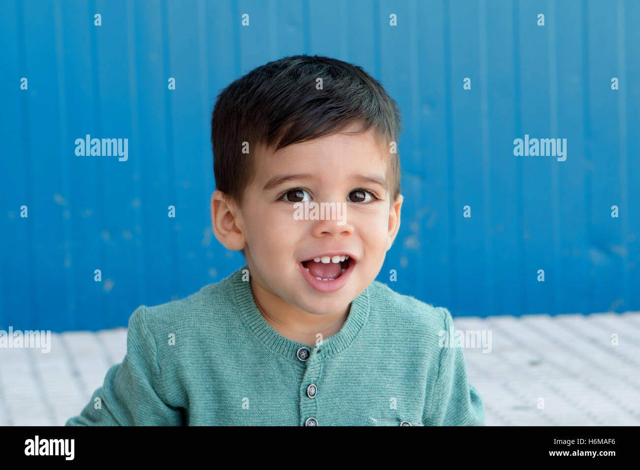 Cheerful child with two years making gestures on the street Stock Photo ...