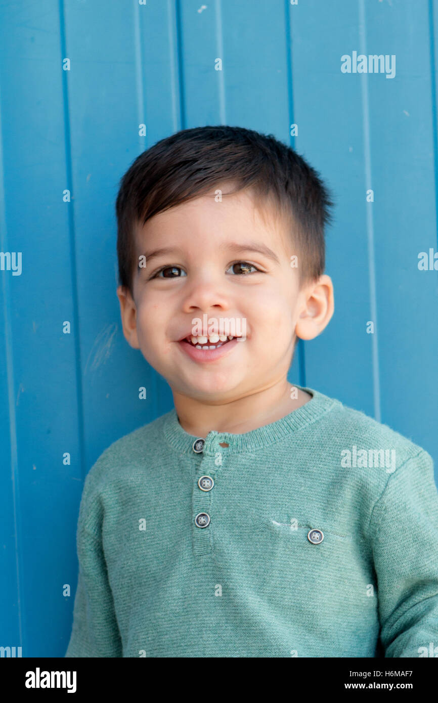 Cheerful child with two years making gestures on the street Stock Photo ...