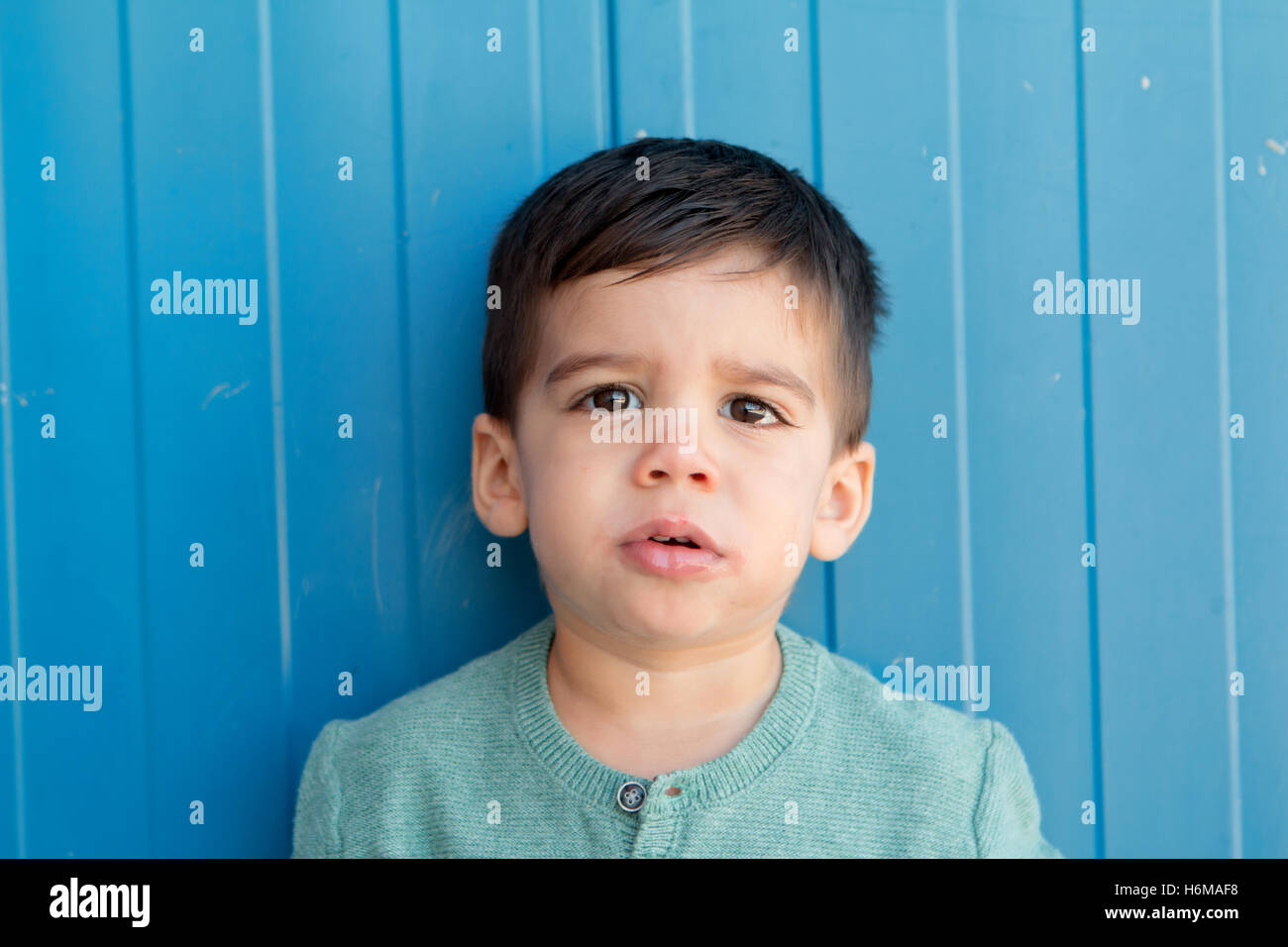 Cheerful child with two years making gestures on the street Stock Photo ...