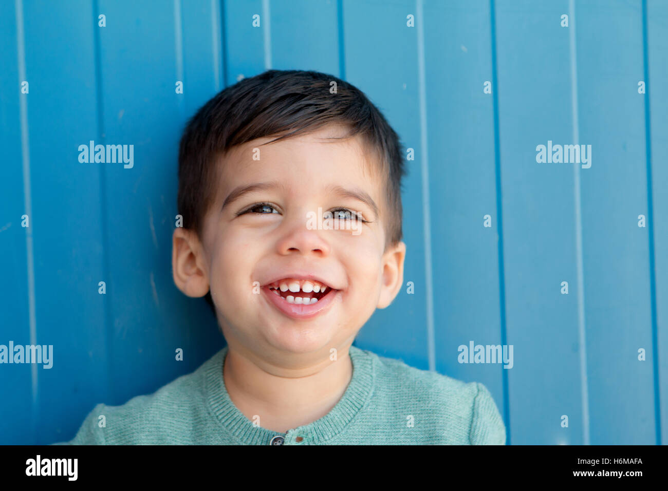 Cheerful child with two years making gestures on the street Stock Photo ...