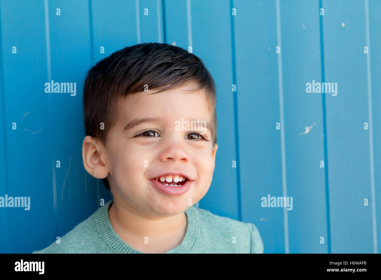 Cheerful child with two years making gestures on the street Stock Photo ...