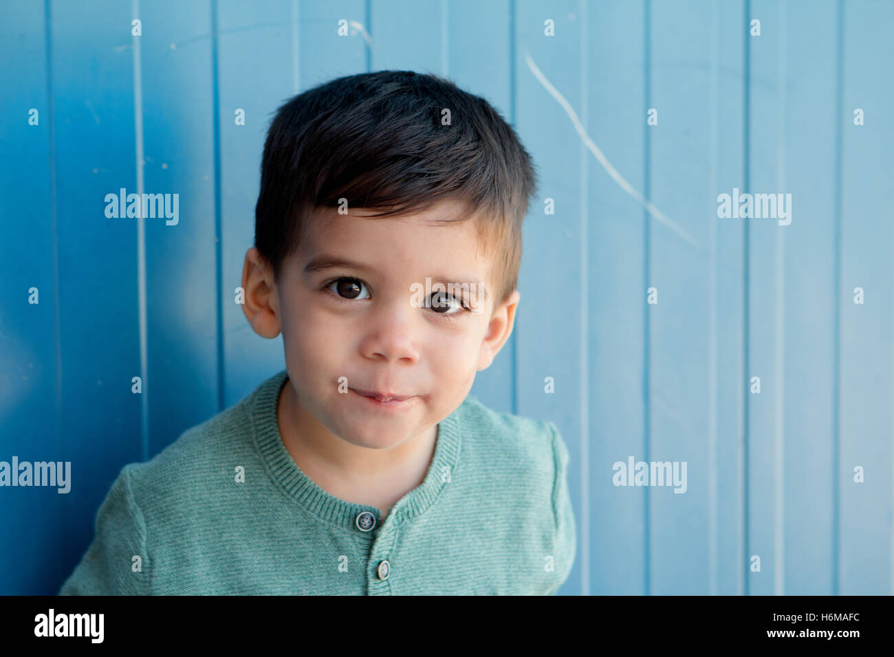 Cheerful child with two years making gestures on the street Stock Photo ...