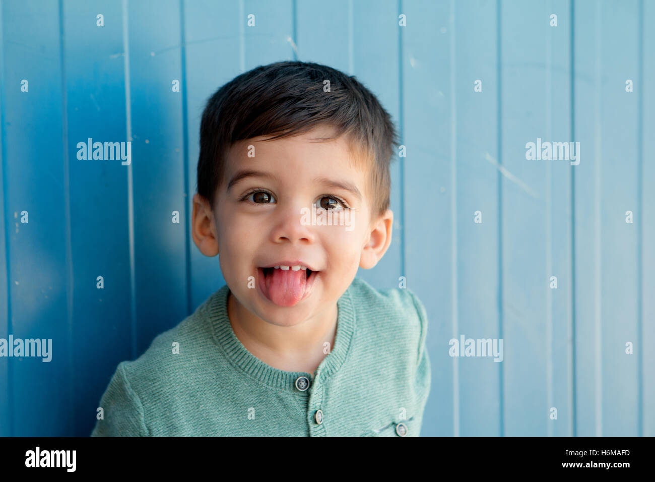 Cheerful child with two years making gestures on the street Stock Photo ...