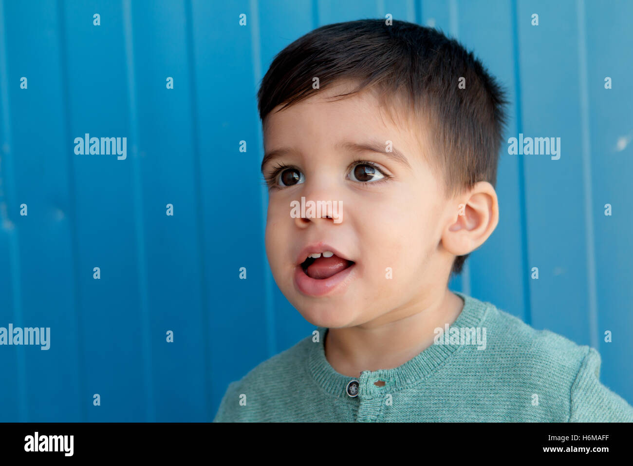 Cheerful child with two years making gestures on the street Stock Photo ...