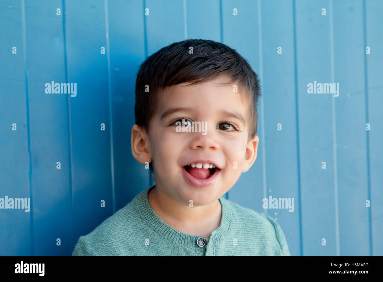Cheerful child with two years making gestures on the street Stock Photo ...