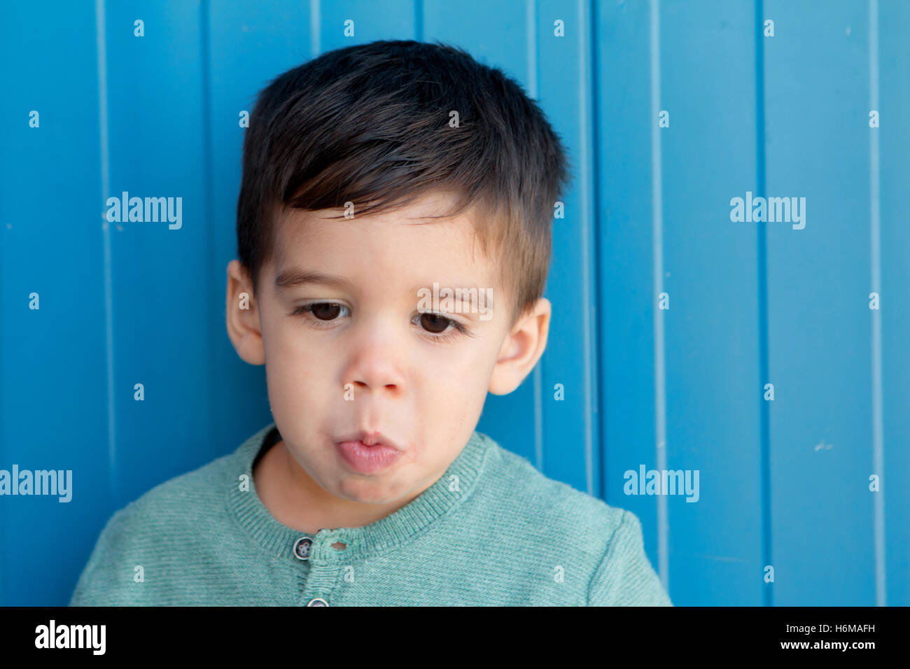 Cheerful child with two years making gestures on the street Stock Photo ...