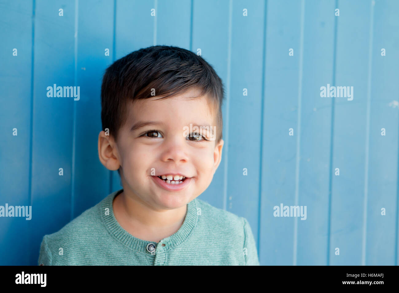 Cheerful child with two years making gestures on the street Stock Photo ...
