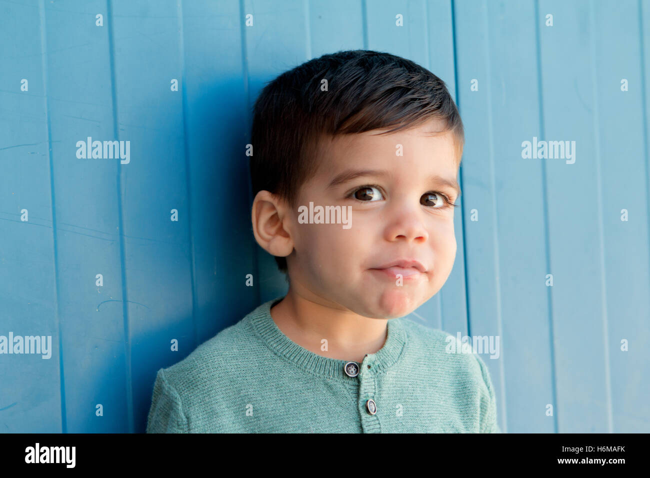 Cheerful child with two years making gestures on the street Stock Photo ...