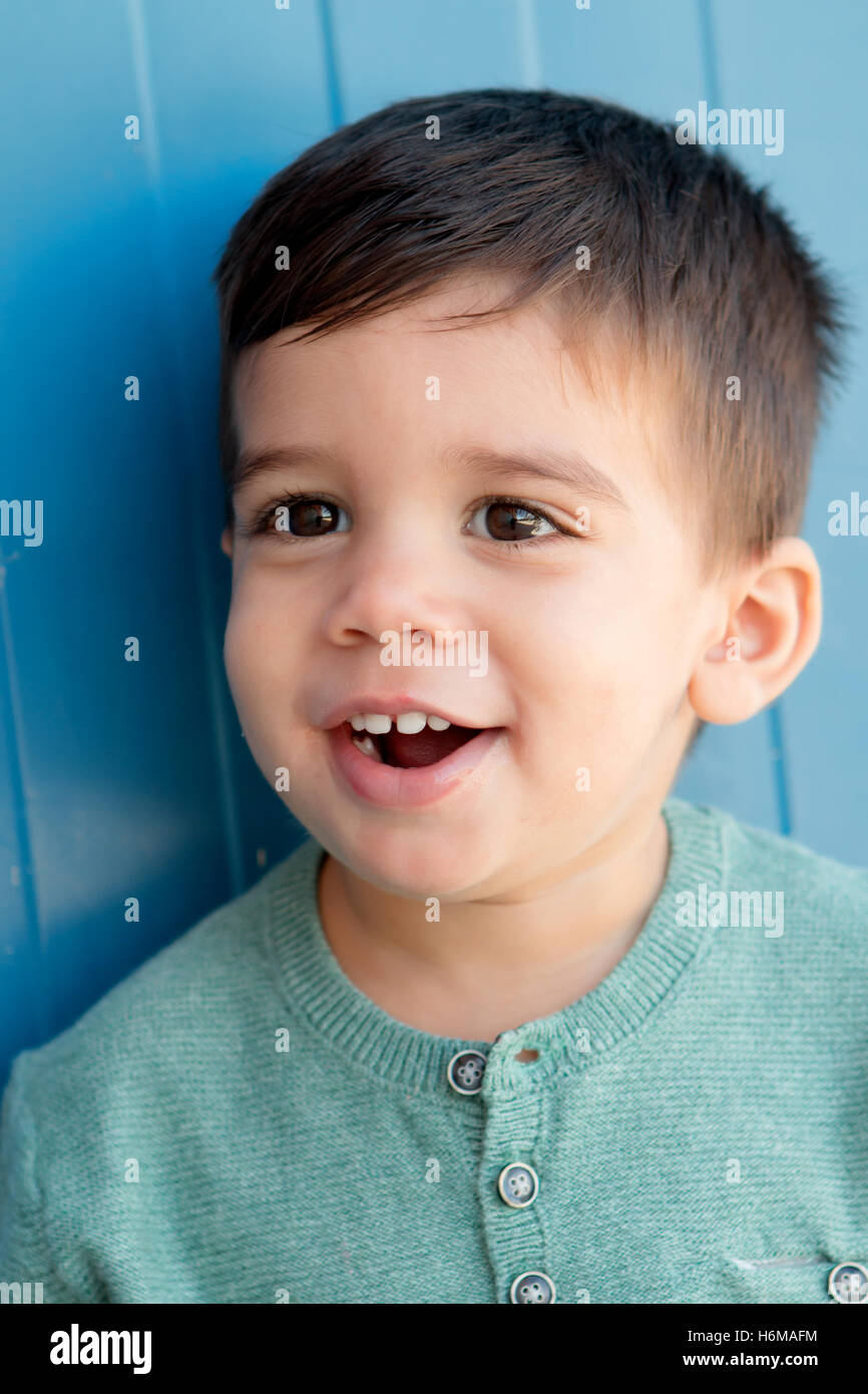 Cheerful child with two years making gestures on the street Stock Photo ...