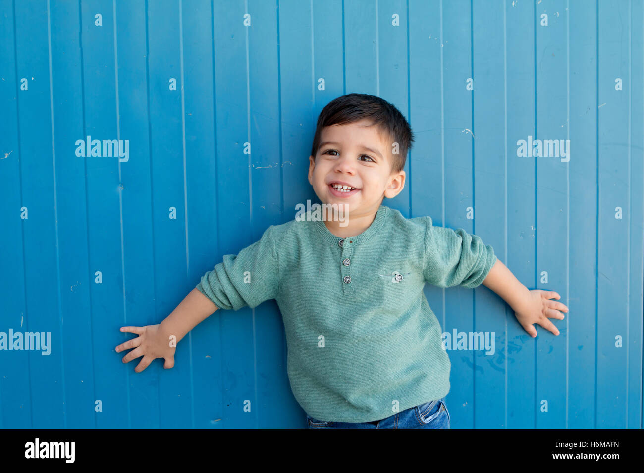 Cheerful child with two years making gestures on the street Stock Photo ...