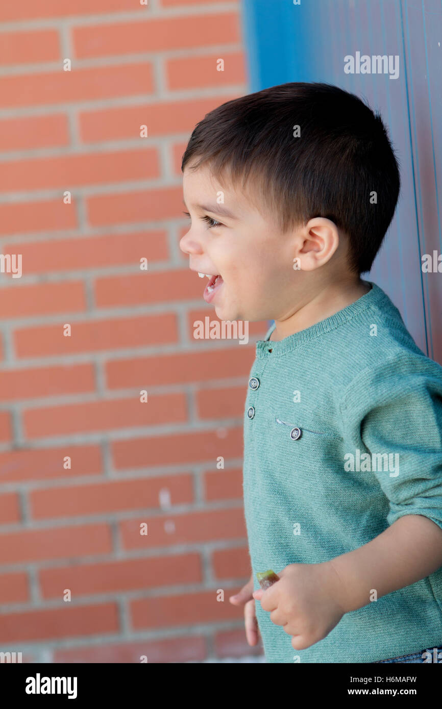 Cheerful child with two years making gestures on the street Stock Photo ...