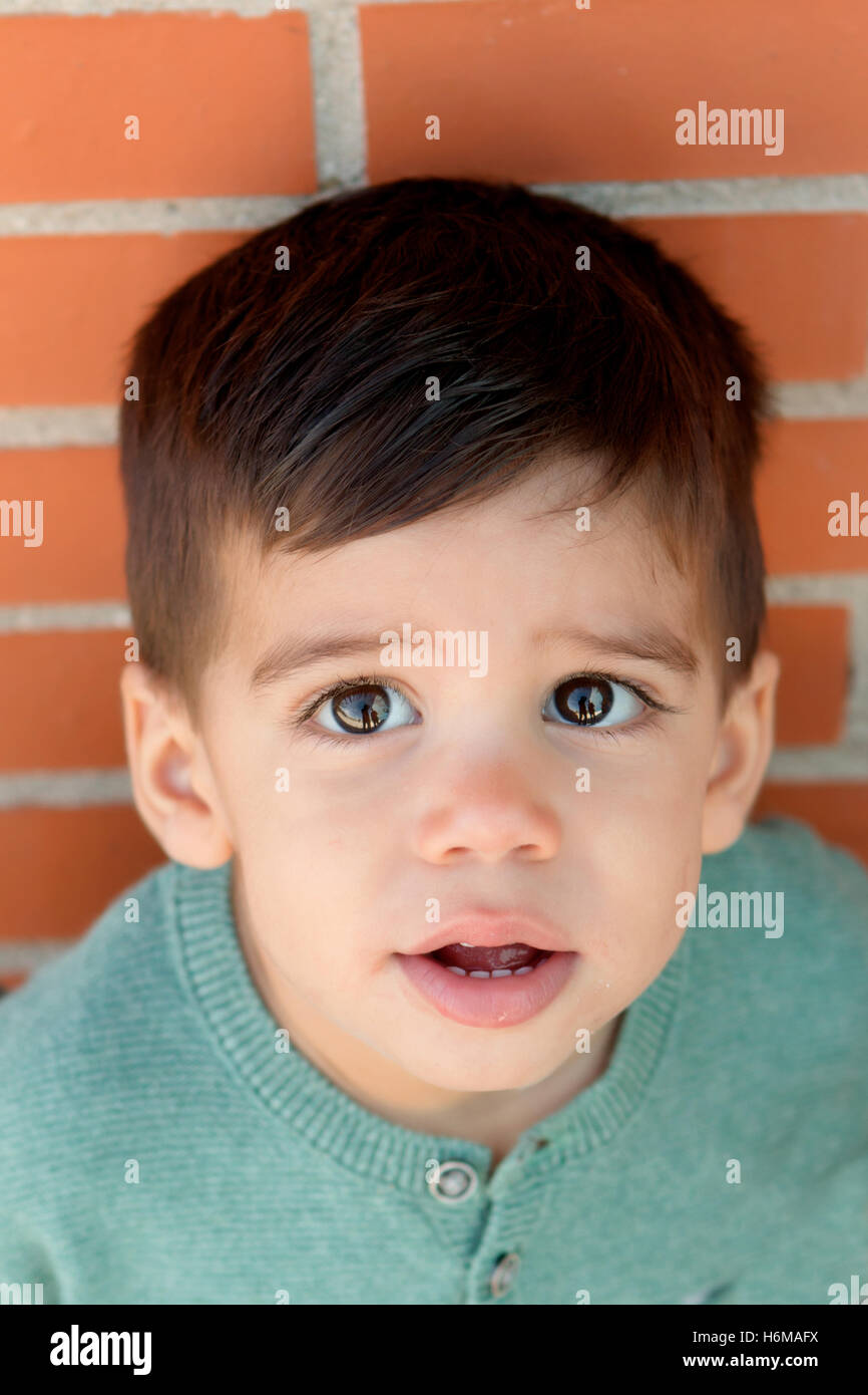 Cheerful child with two years making gestures on the street Stock Photo ...