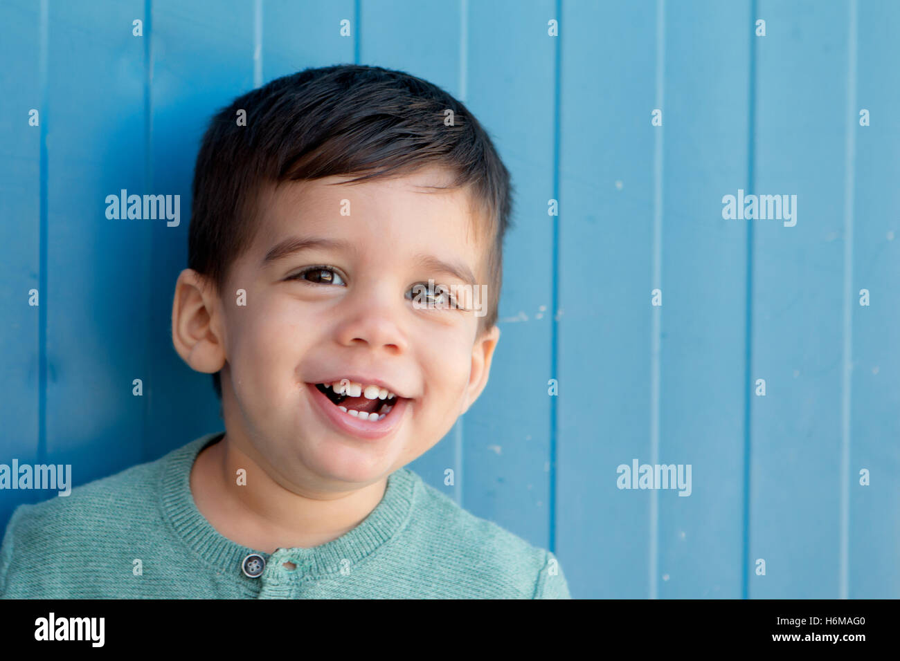 Cheerful child with two years making gestures on the street Stock Photo ...