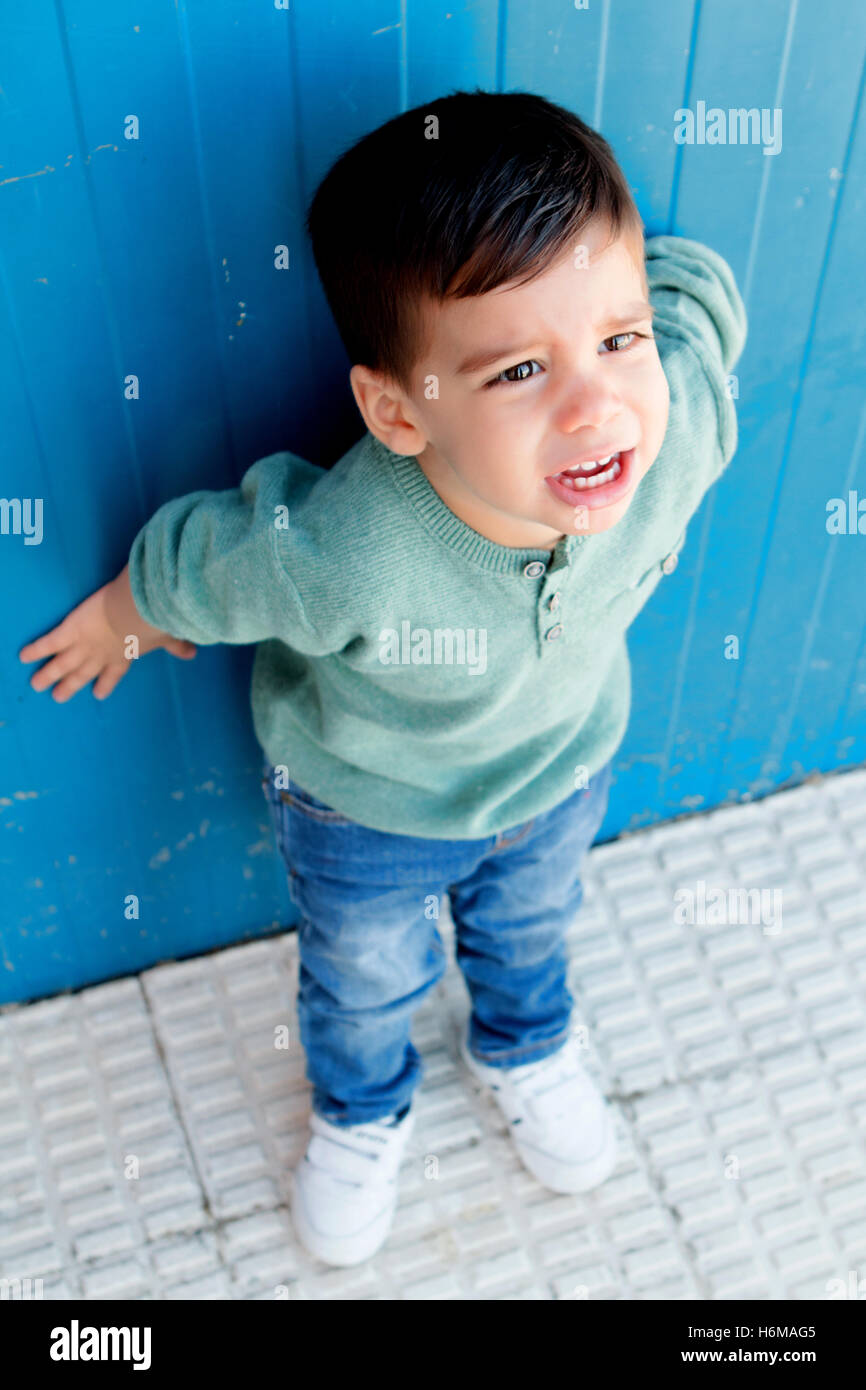 Sad child with two years crying on the street Stock Photo - Alamy