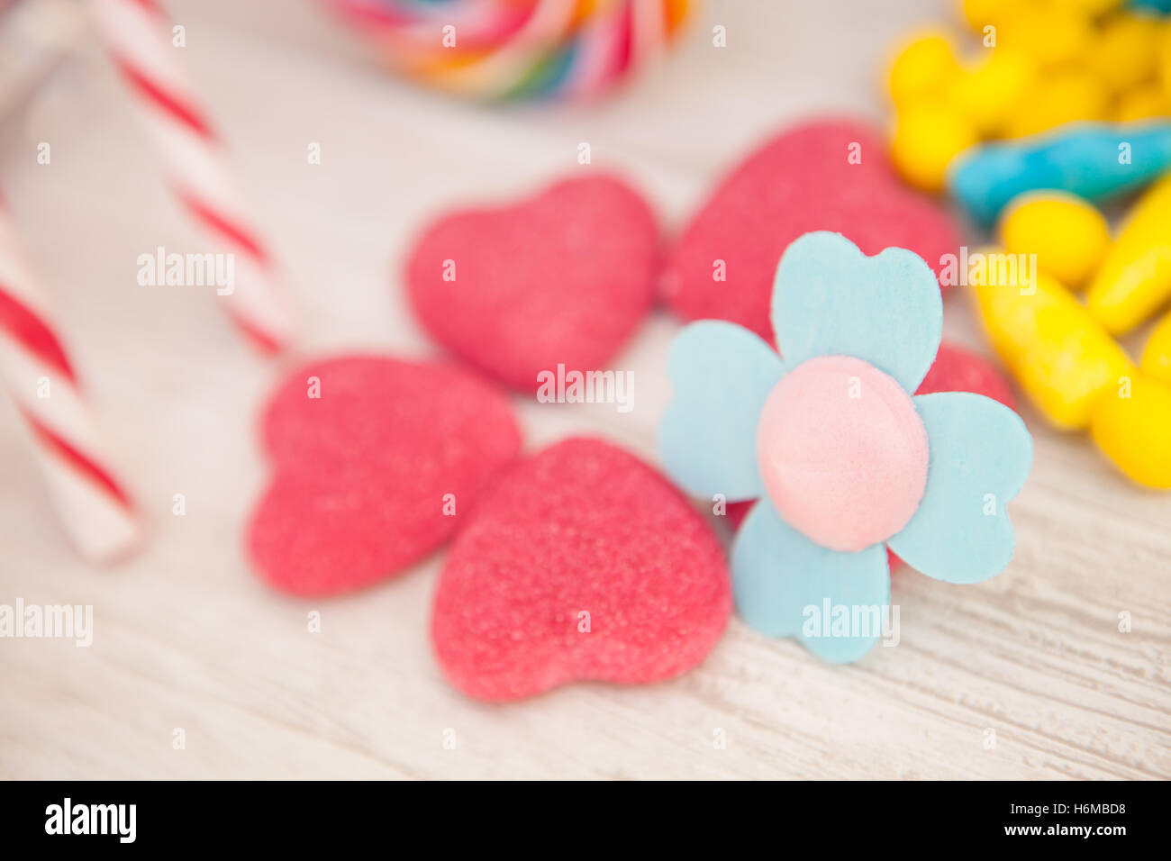 Candies with different shapes and colors on a gray wooden background ...