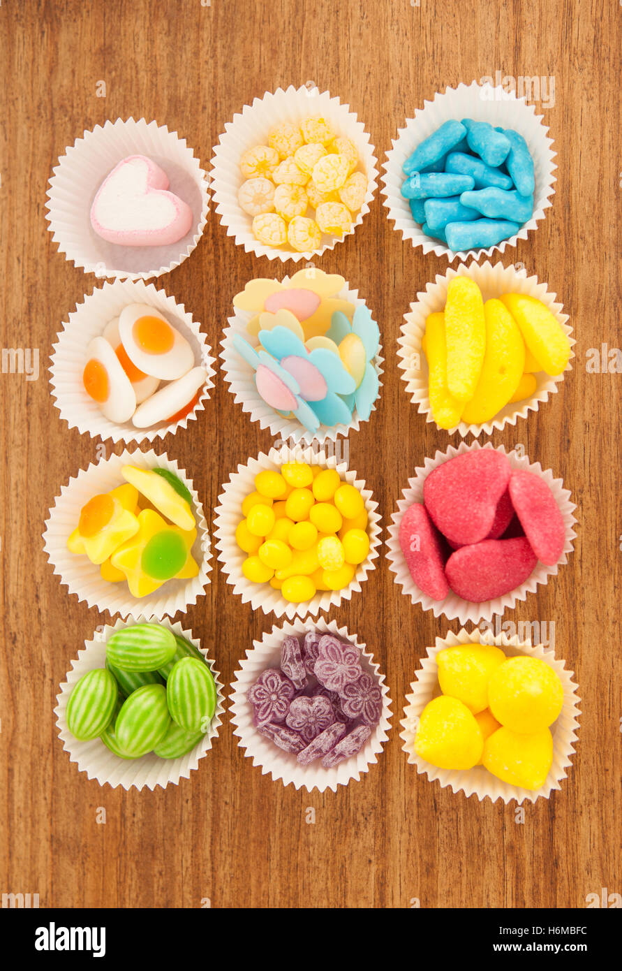 Many types of candies placed in small bowls by type and color Stock ...