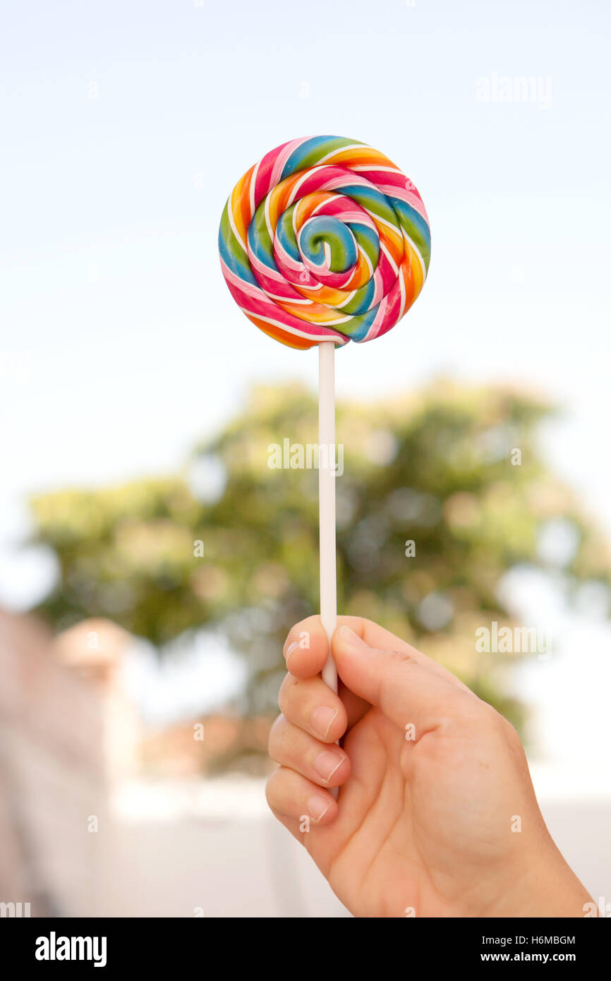 Nice round lollipop with many colors in a spiral Stock Photo - Alamy