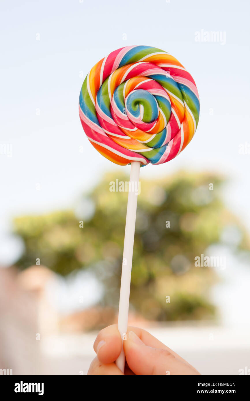 Nice round lollipop with many colors in a spiral Stock Photo - Alamy