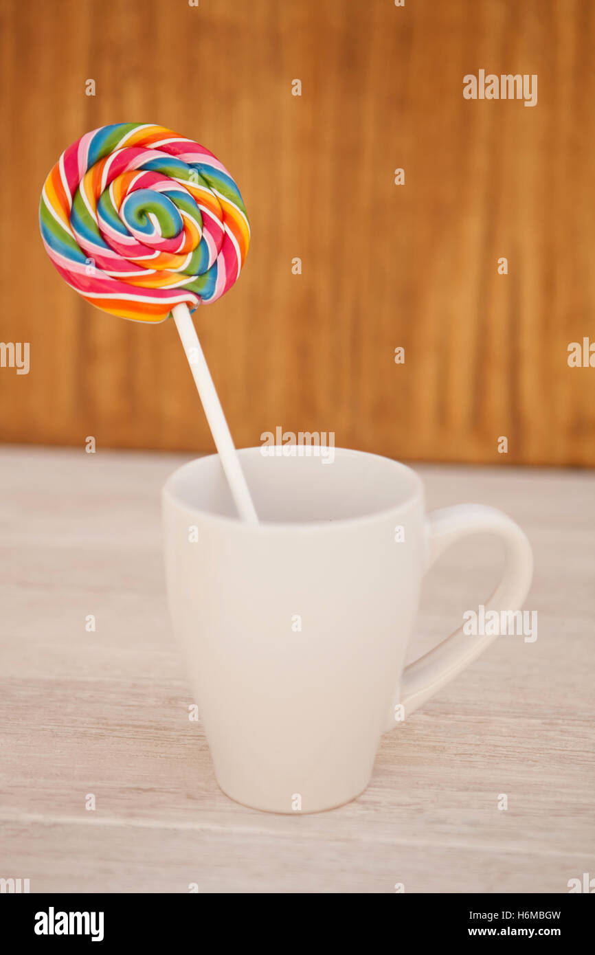 Nice round lollipop with many colors in a spiral in a cup Stock Photo ...