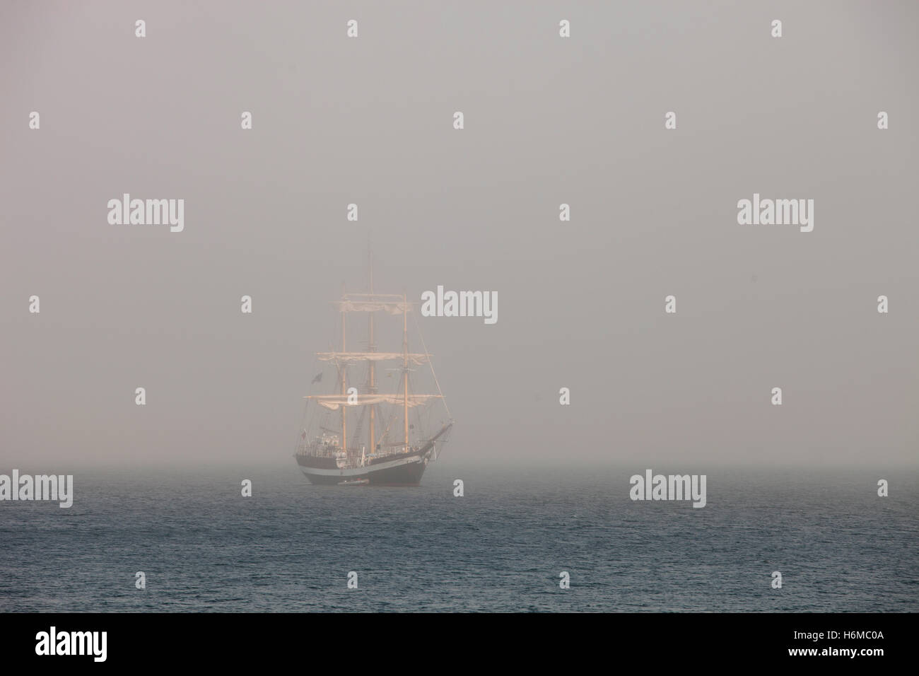 Mysterious sailing ship surrounded fog sailing on blue ocean Stock ...