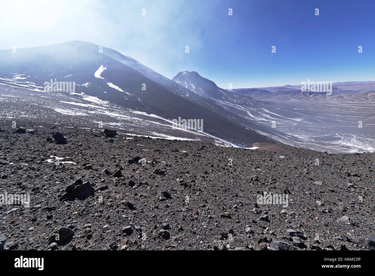 View from the top of a high mountain with volcanoes on the front left ...