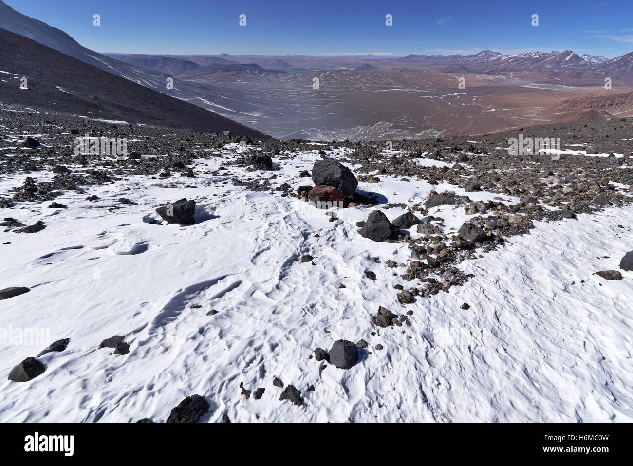 Snowy summit of mountain with a magnificent view to a valley down ...