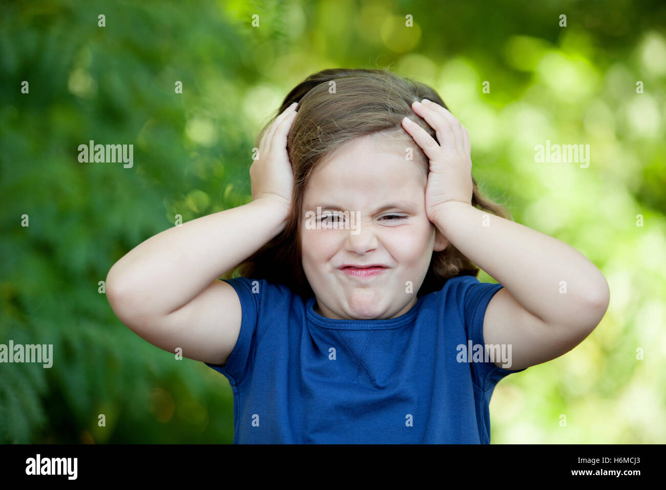 Cute little girl in the park expressing surprise Stock Photo - Alamy
