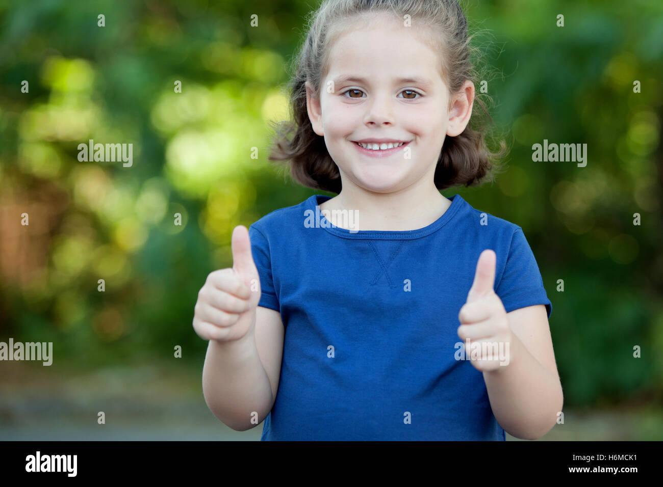 Cute little girl in a summer day saying Ok Stock Photo - Alamy