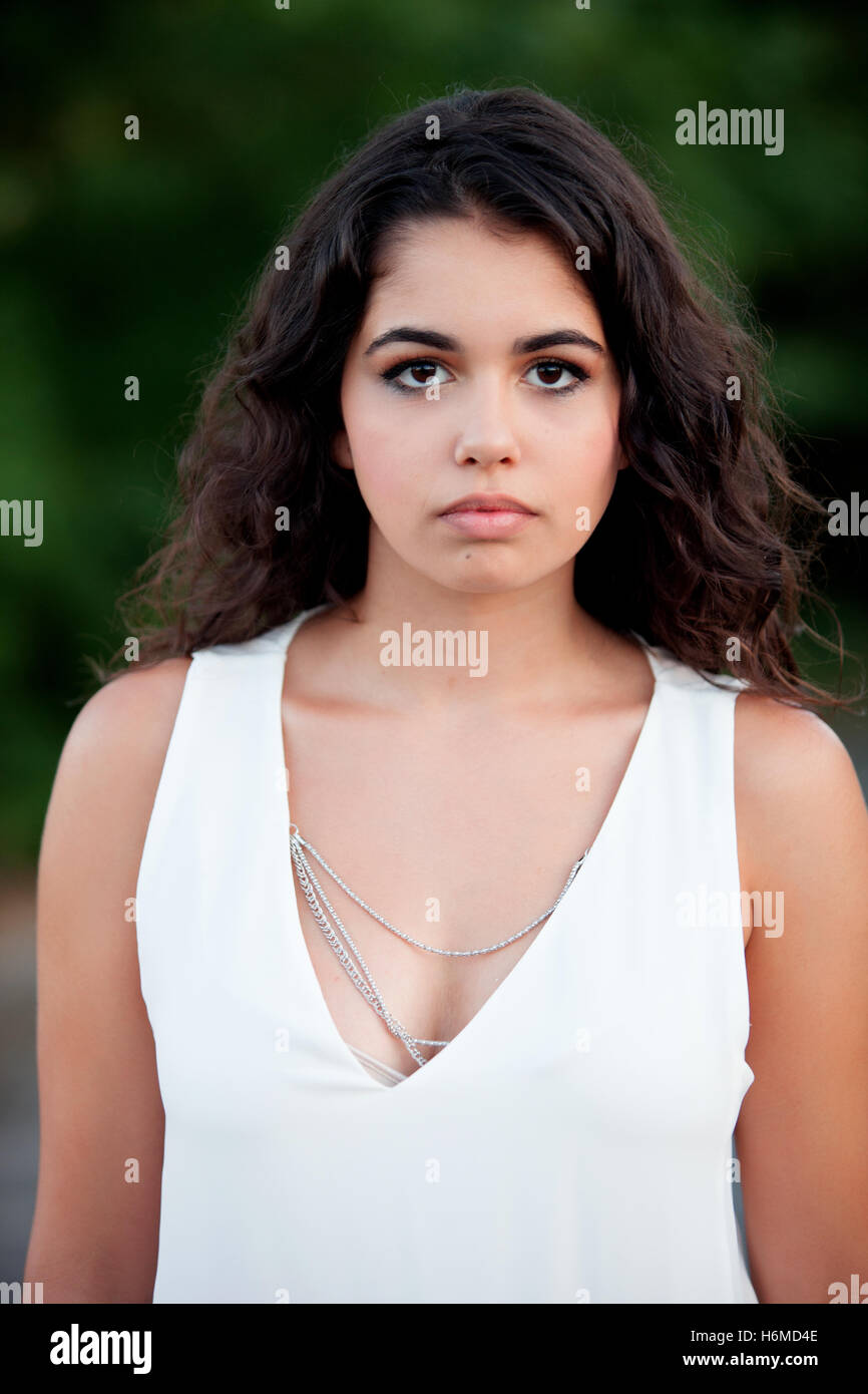 Beautiful brunette girl relaxing in the park wiht many plants of ...