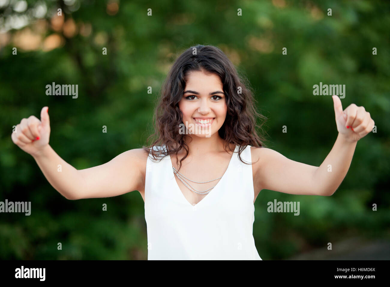 Beautiful Brunette Girl Relaxing In The Park Wiht Many Plants Of