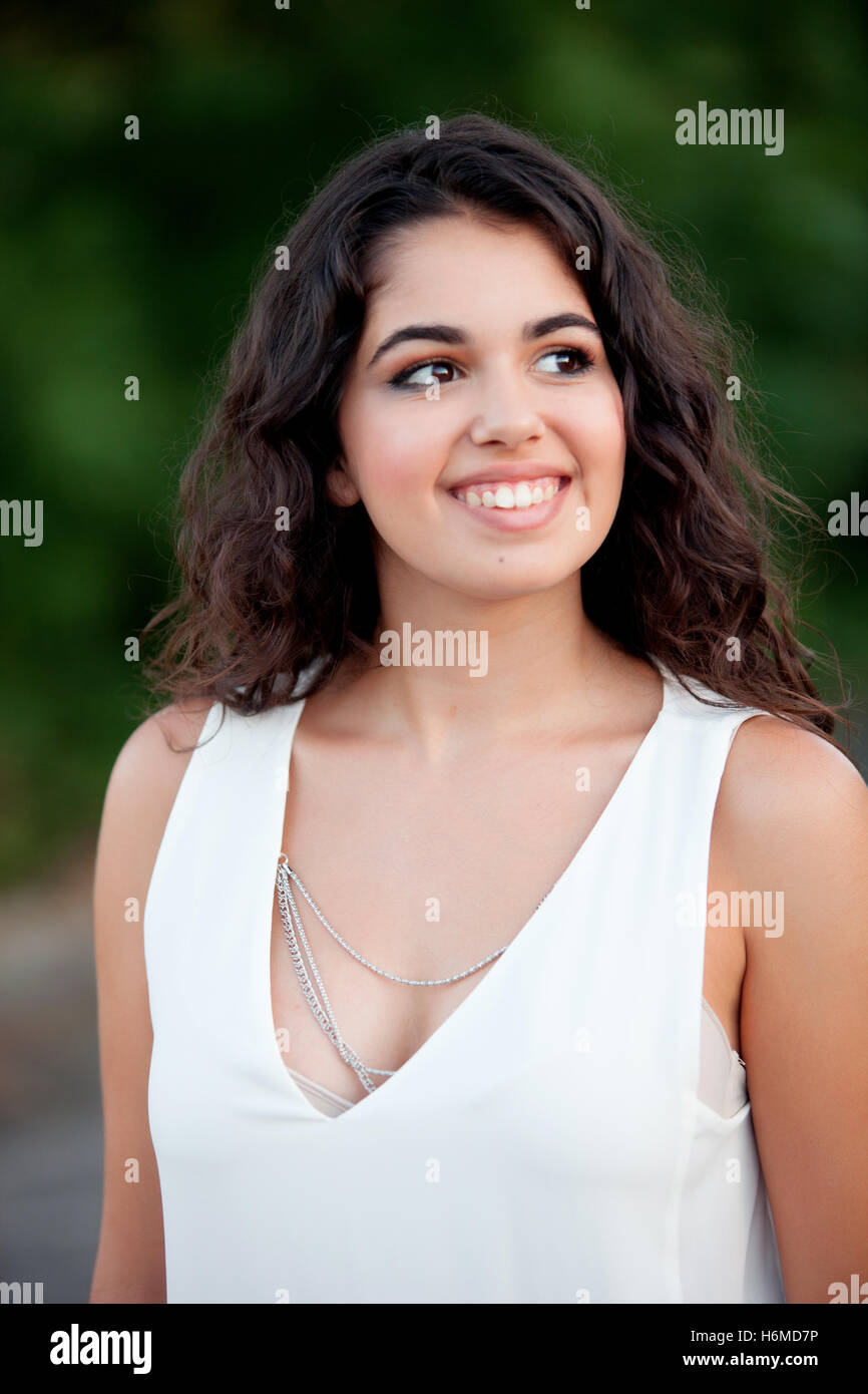Beautiful Brunette Girl Relaxing In The Park Wiht Many Plants Of