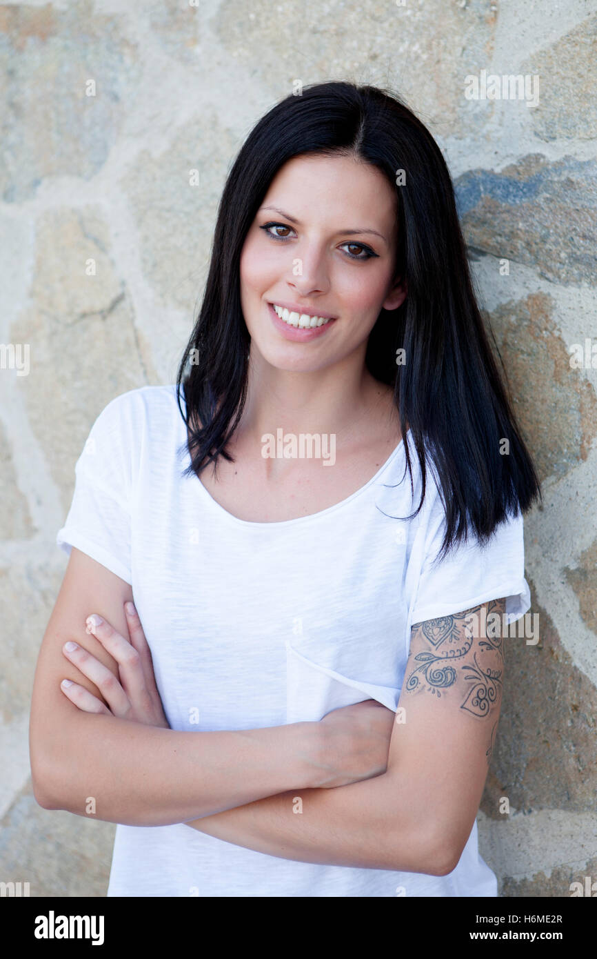 Cool young woman during a photo shoot on the street with a tatto on arm ...