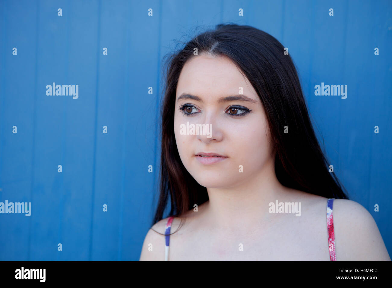 Teenage girl with a blue background on the outside Stock Photo - Alamy