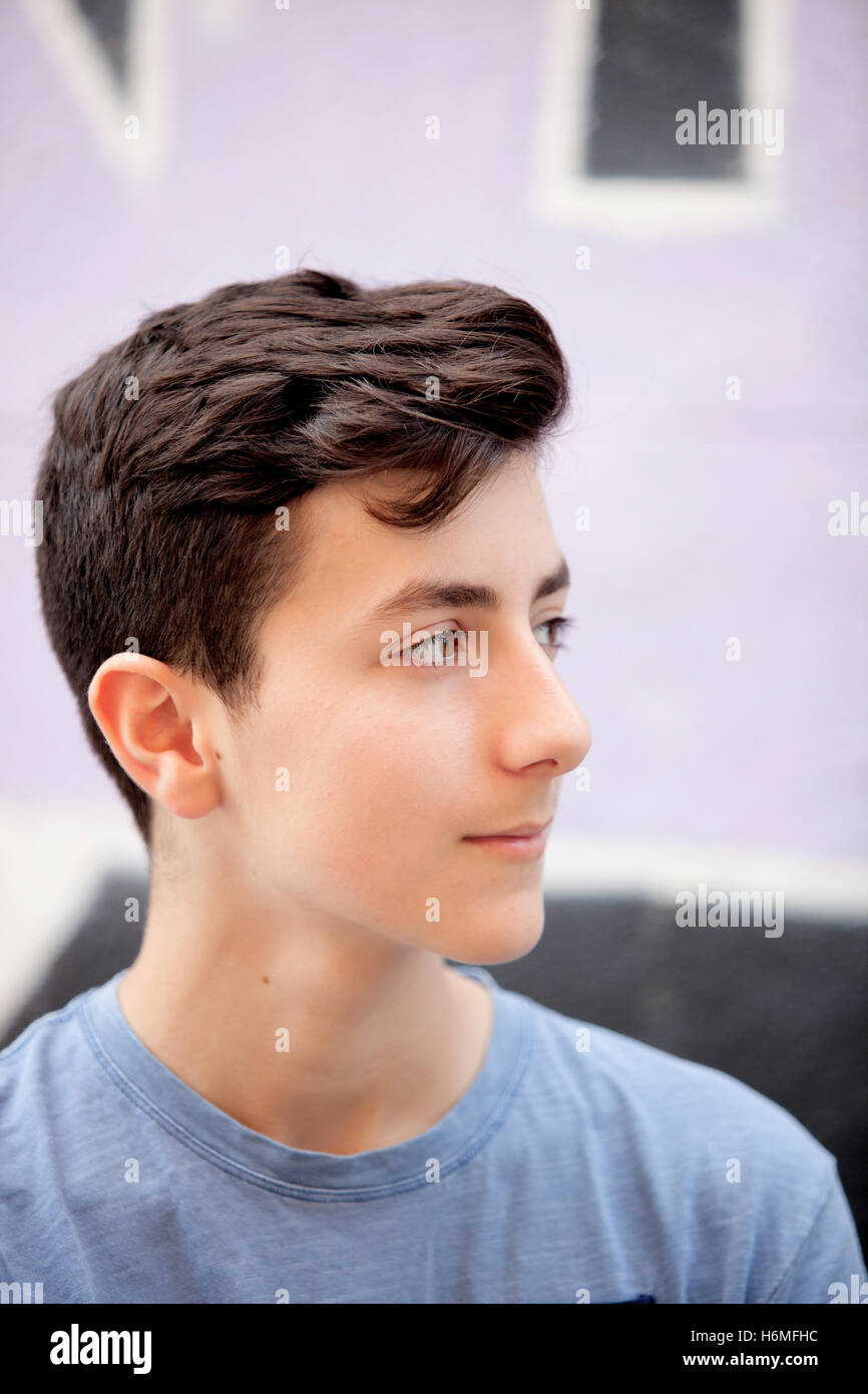 Portrait of a teenager rebellious man on a wall with graffiti ...