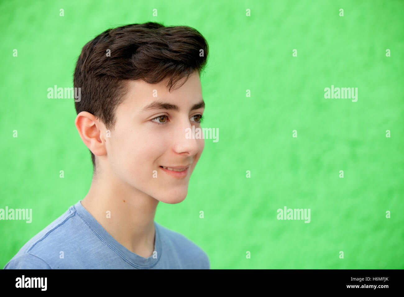 Portrait of a teenager rebellious man with a green background Stock ...